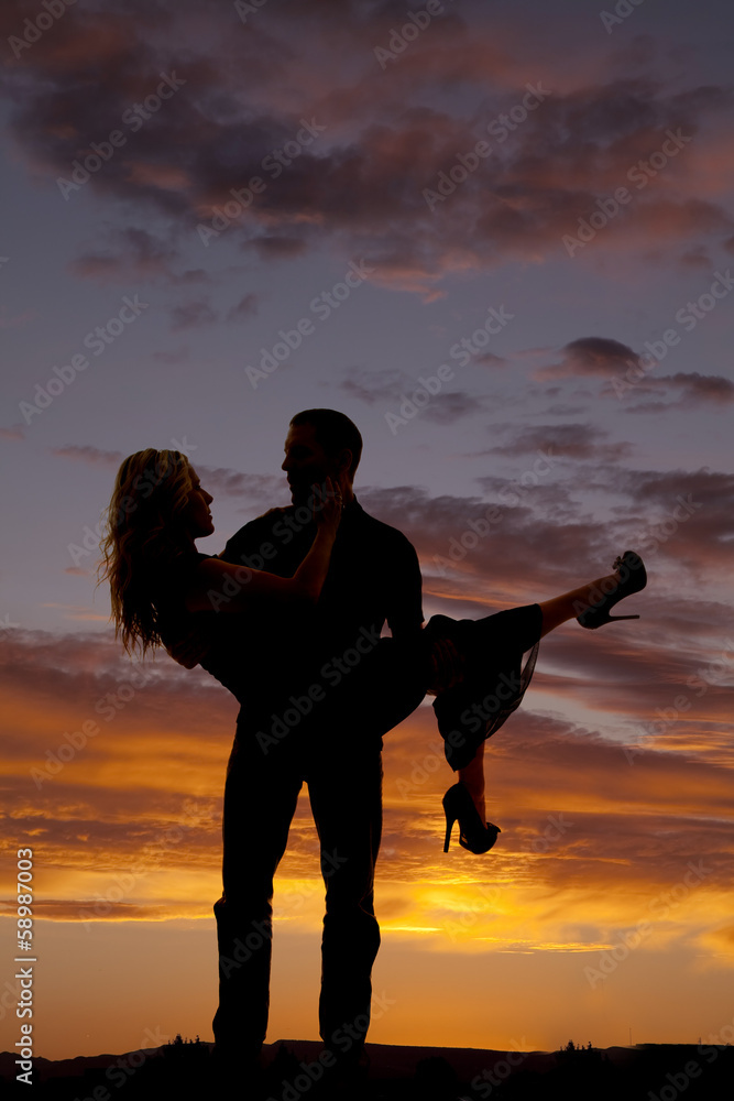 silhouette man lifting woman look at each other Stock Photo | Adobe Stock