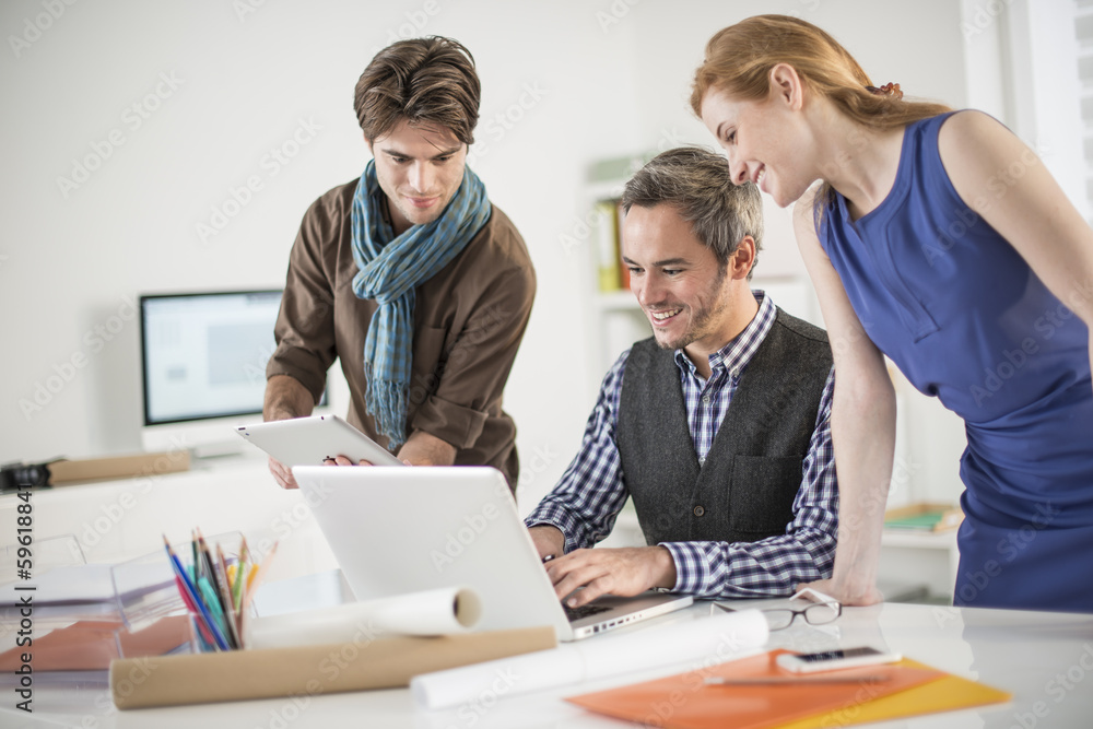 team discusses about a work project around a computer Stock Photo ...