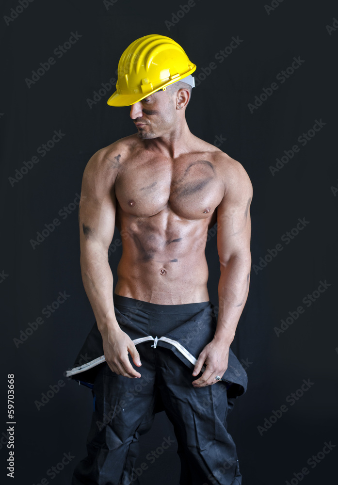 Shirtless muscular construction worker with coverall and hardhat Stock ...