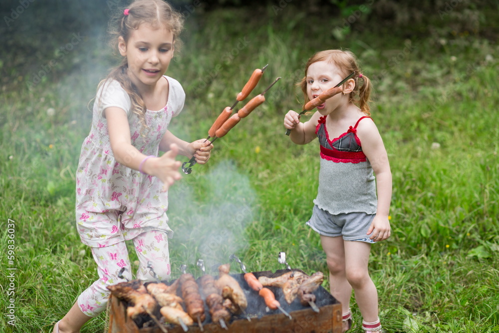 Two little girl making barbecue on grill on nature Stock Photo | Adobe ...