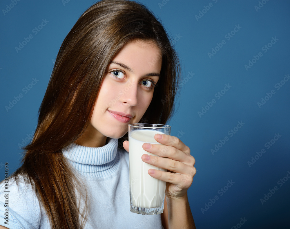 beautiful cheerful teen girl drinkink milk over blue Stock Photo ...
