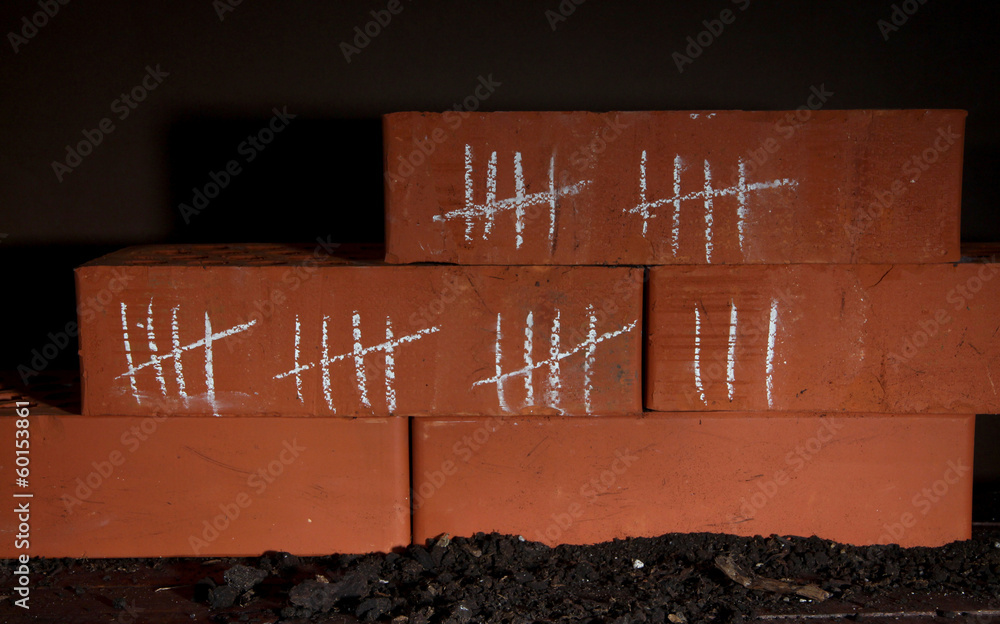 Counting days by drawing sticks on bricks on dark background Stock ...