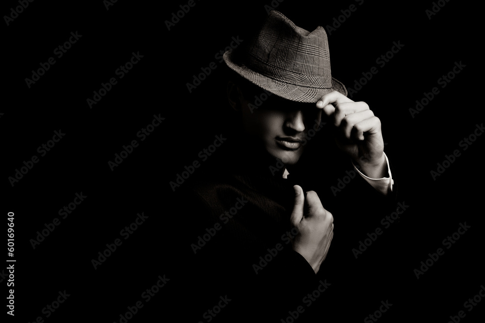 low key portrait of young gangster with hat in the darkness. Stock ...