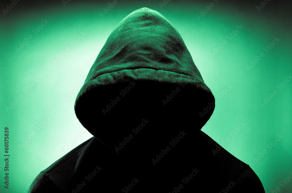 Man wearing hood with face in shadow Stock Photo | Adobe Stock