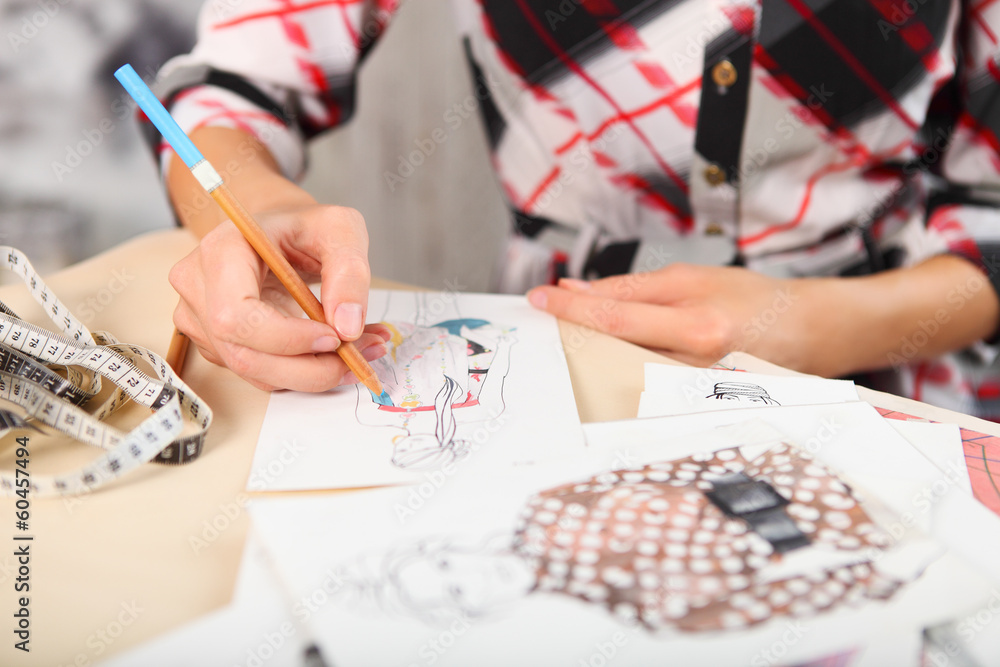 Dressmaker is drawing a fashion sketch Stock Photo | Adobe Stock