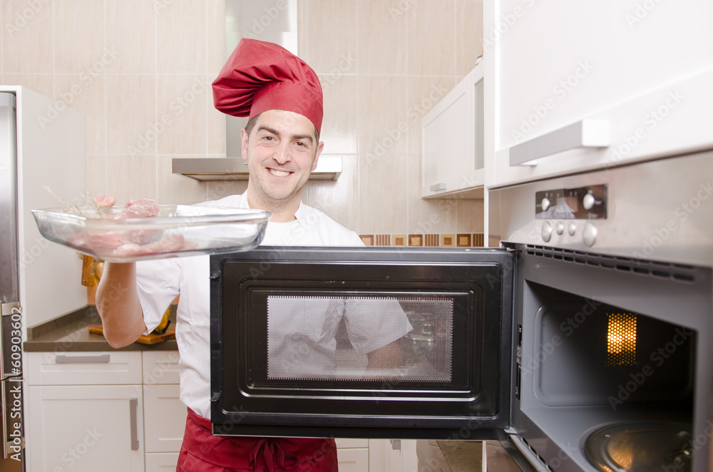 The chef in the kitchen.Cooking with microwave oven Stock Photo | Adobe ...