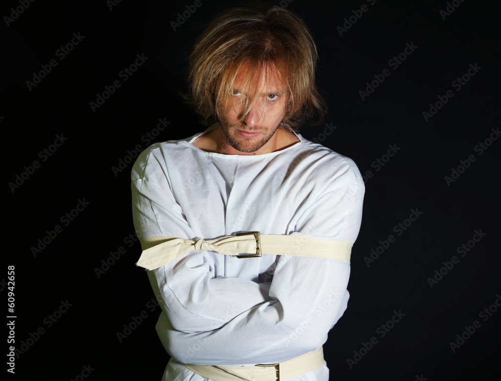Mentally ill man in strait-jacket on black background Stock Photo ...