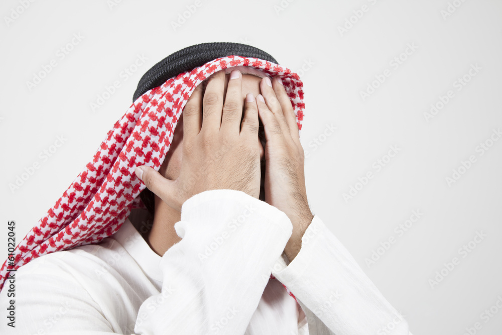 Arab sheikh man covering his face in shame forgiveness pain Stock Photo ...