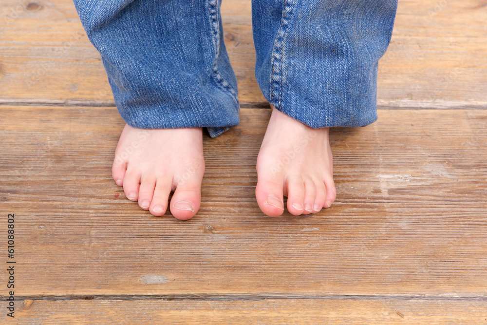 Young girl barefoot on wooden floor Stock Photo | Adobe Stock