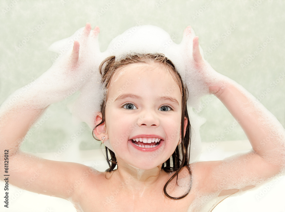 Happy little girl washing in bath with foam Stock Photo | Adobe Stock
