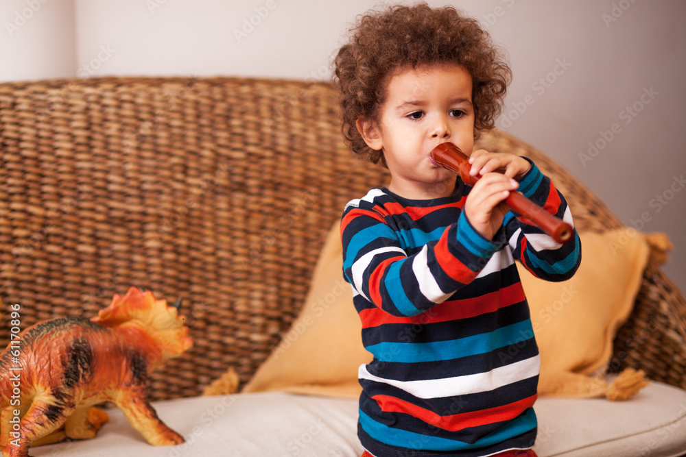 Kid playing flute foto de Stock | Adobe Stock