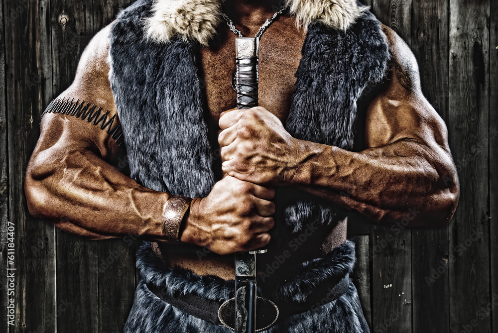 Strong muscular man defender warrior with sword in hand Stock Photo ...