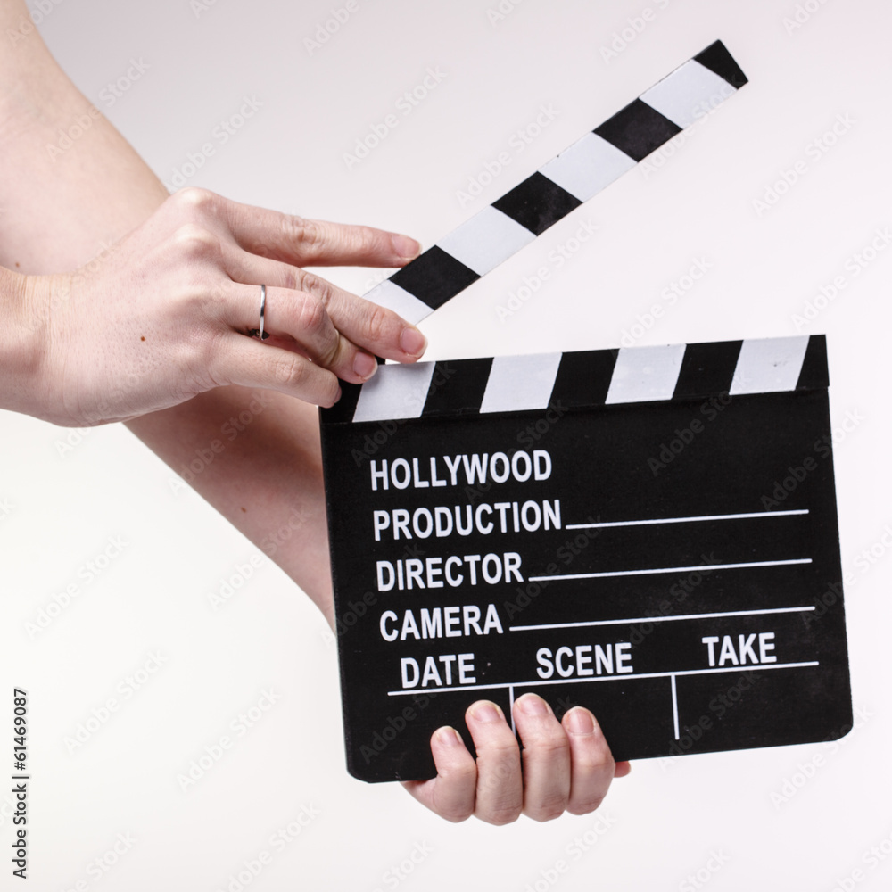 Movie flapper in woman´s hands on white background Stock Photo | Adobe ...