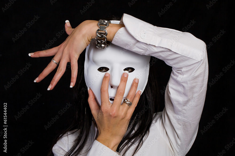 Beautiful woman hiding behind a mask foto de Stock | Adobe Stock