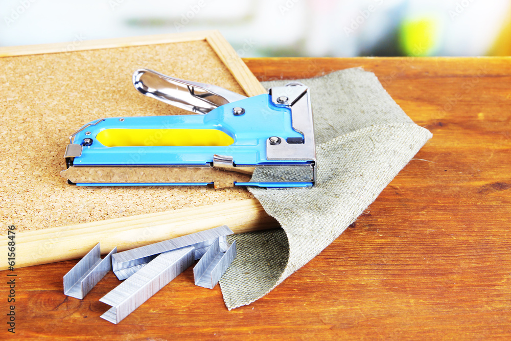 Construction stapler with staples and cork board Stock Photo | Adobe Stock