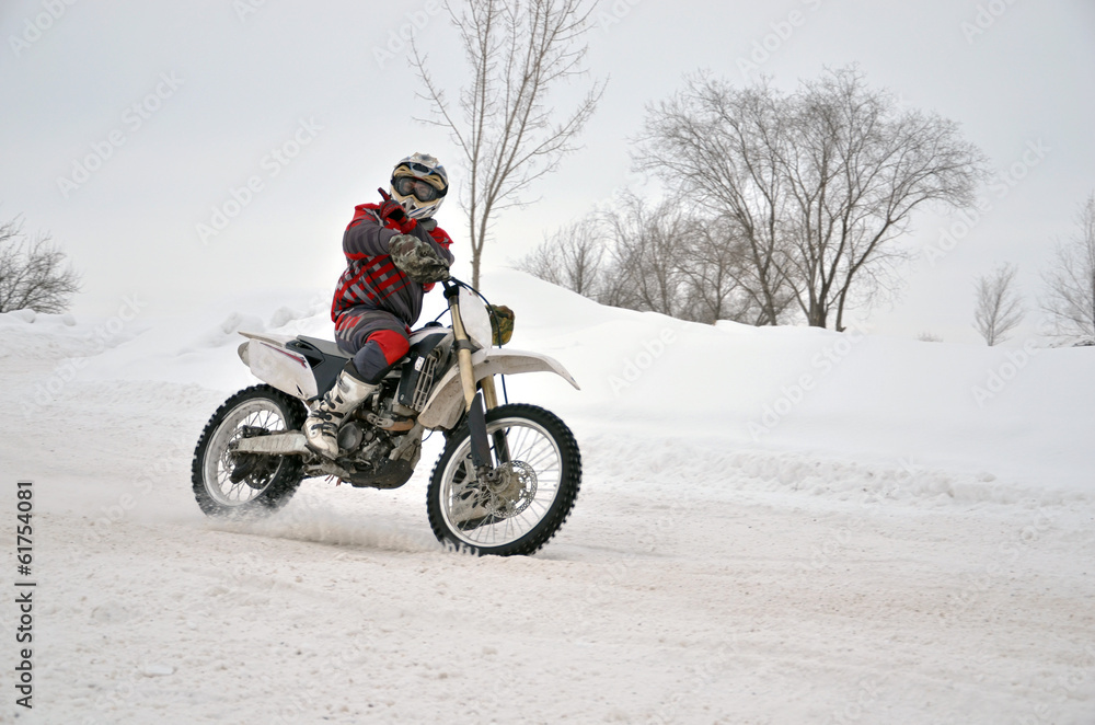 Motocross on snow, the driver manages motorcycle one arm on snow Stock ...