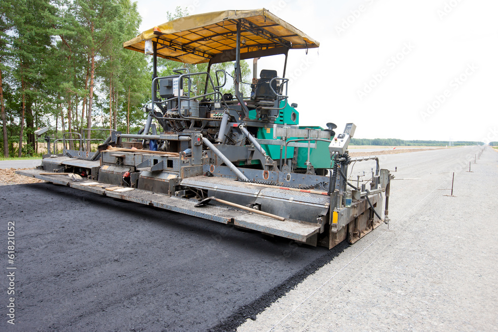 Tracked paver laying fresh asphalt pavement Stock Photo | Adobe Stock