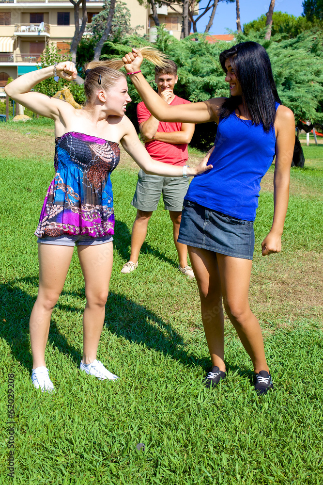 Man enjoying watching cat fight between girlfriends Stock Photo | Adobe ...