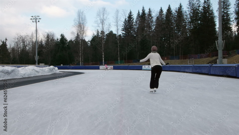 woman figure skating at an open outdoor speed skating rink rear Stock ...