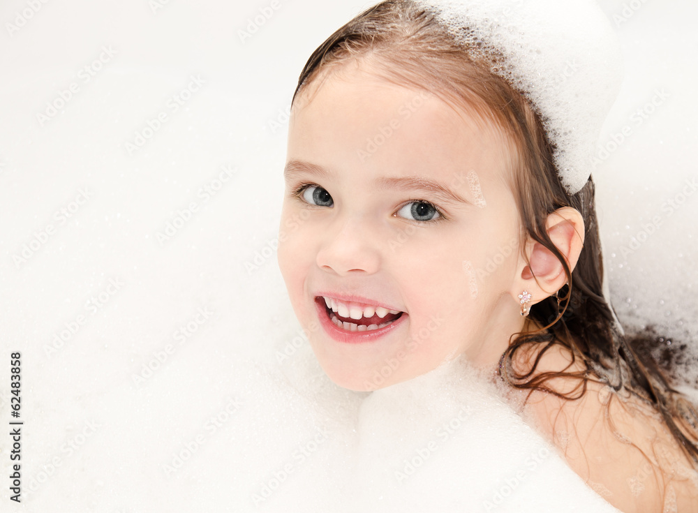 Smiling little girl washing in bath with foam Stock Photo | Adobe Stock