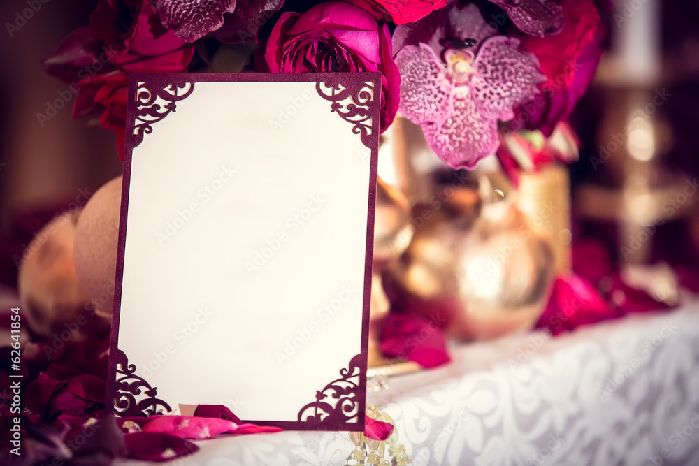 Pretty colored table with invitation note on it Photos | Adobe Stock