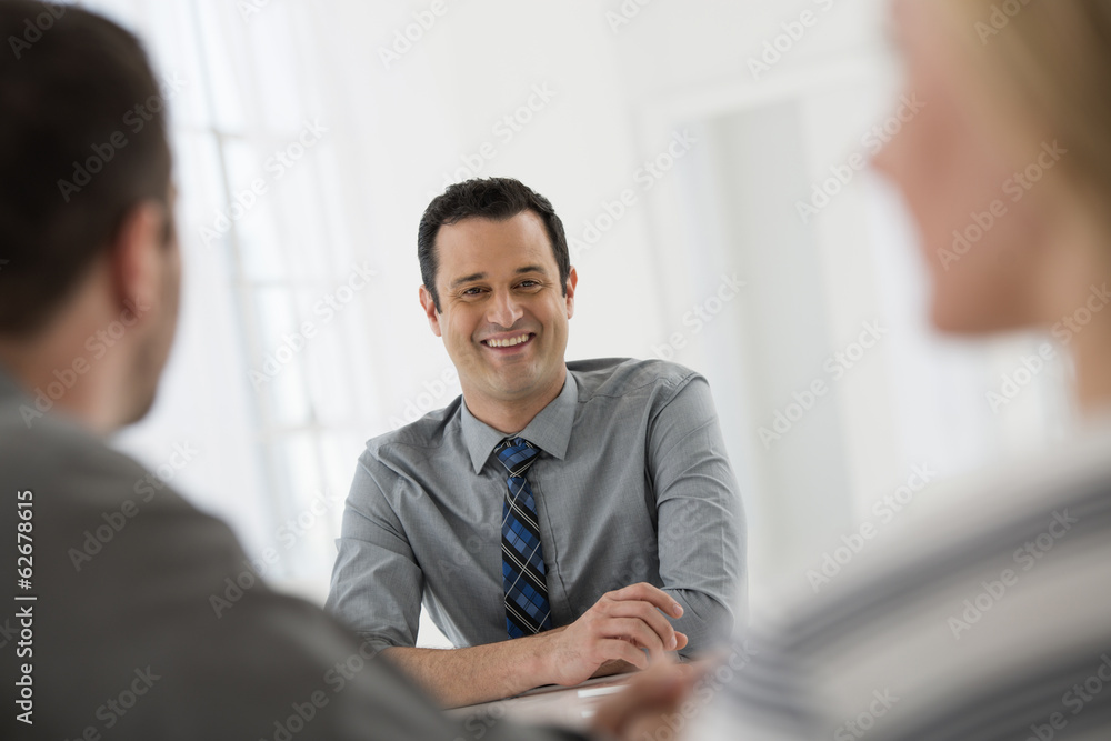 Office Interior. Three People Sitting Around A Table At A Business ...