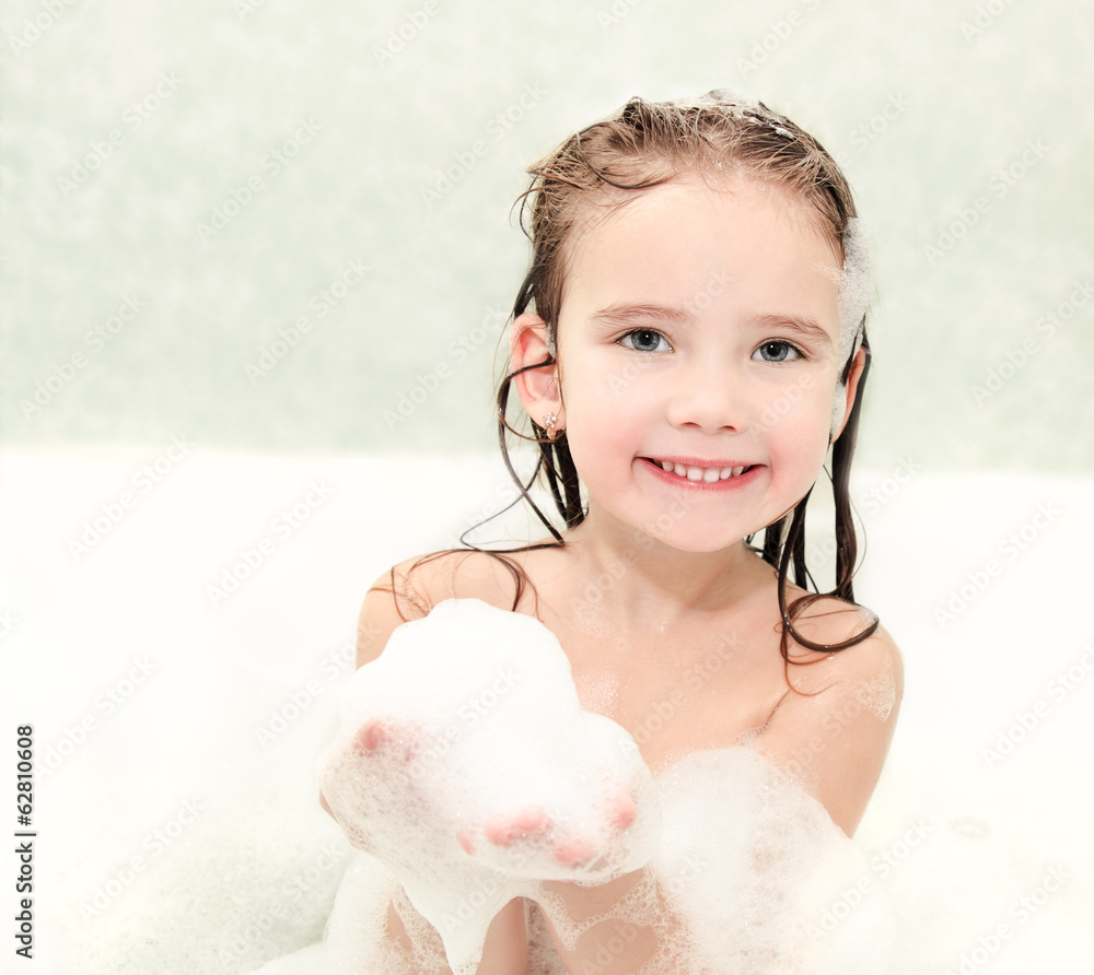 Smiling little girl washing in bath with foam Stock Photo | Adobe Stock