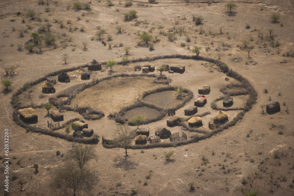 An aerial view of a small rural village settlement, with traditional ...