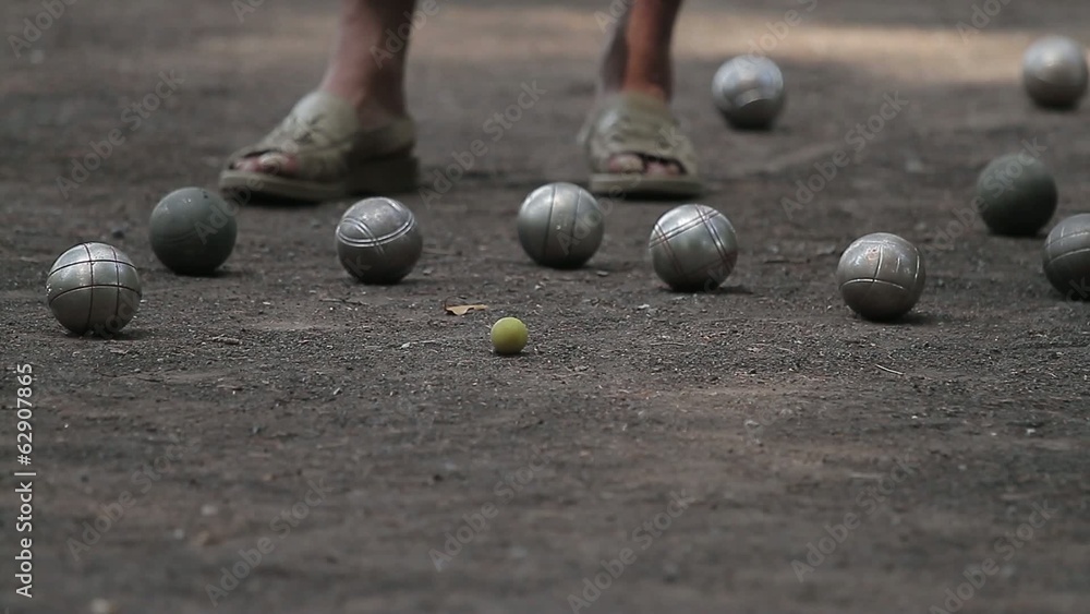 Vidéo Stock elderly people enjoying to play boules in a park, ball ...