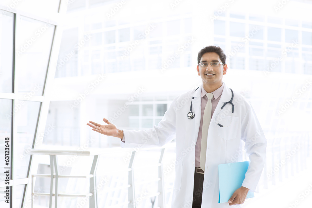 Asian Indian male medical doctor showing welcome hand sign Stock Photo ...