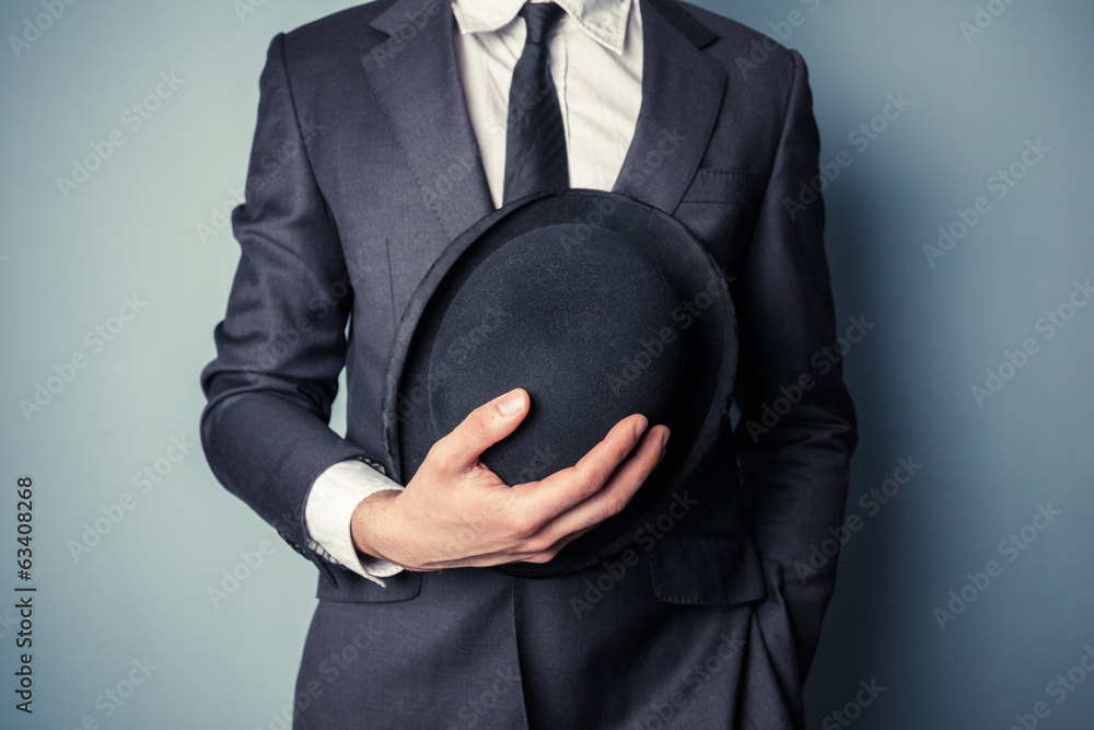Man holding a bowler hat Stock Photo | Adobe Stock
