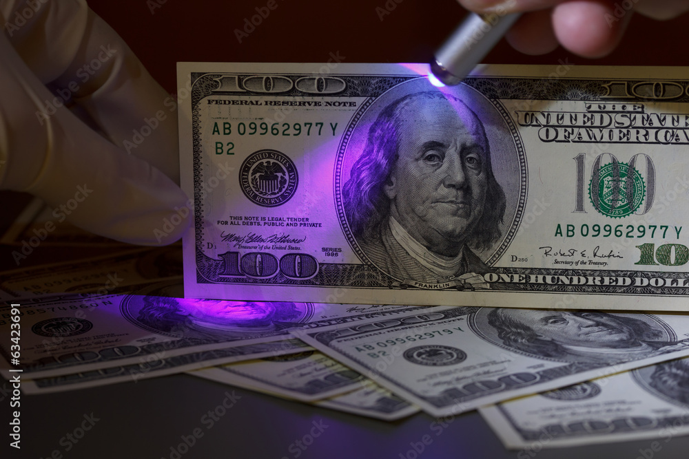 Dollar bill in uv light, fraud check Stock Photo | Adobe Stock