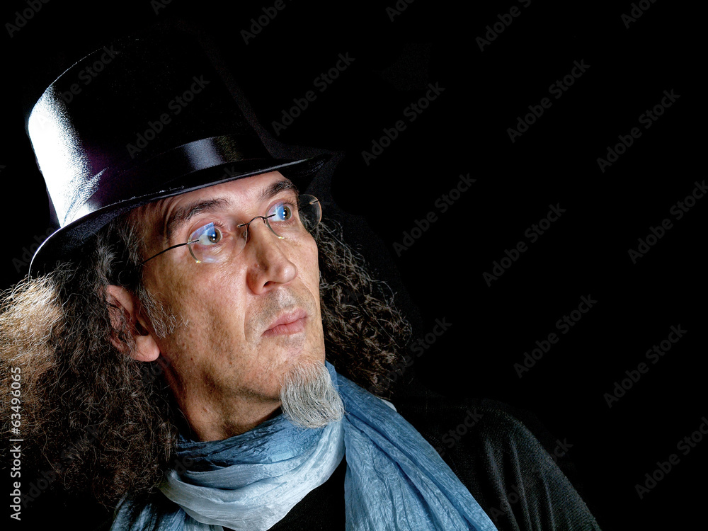 Man with long hair, goatee beard and top hat on black background Stock ...