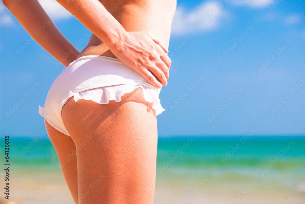 back view of fit young woman's bottom in white bikini Stock Photo | Adobe Stock