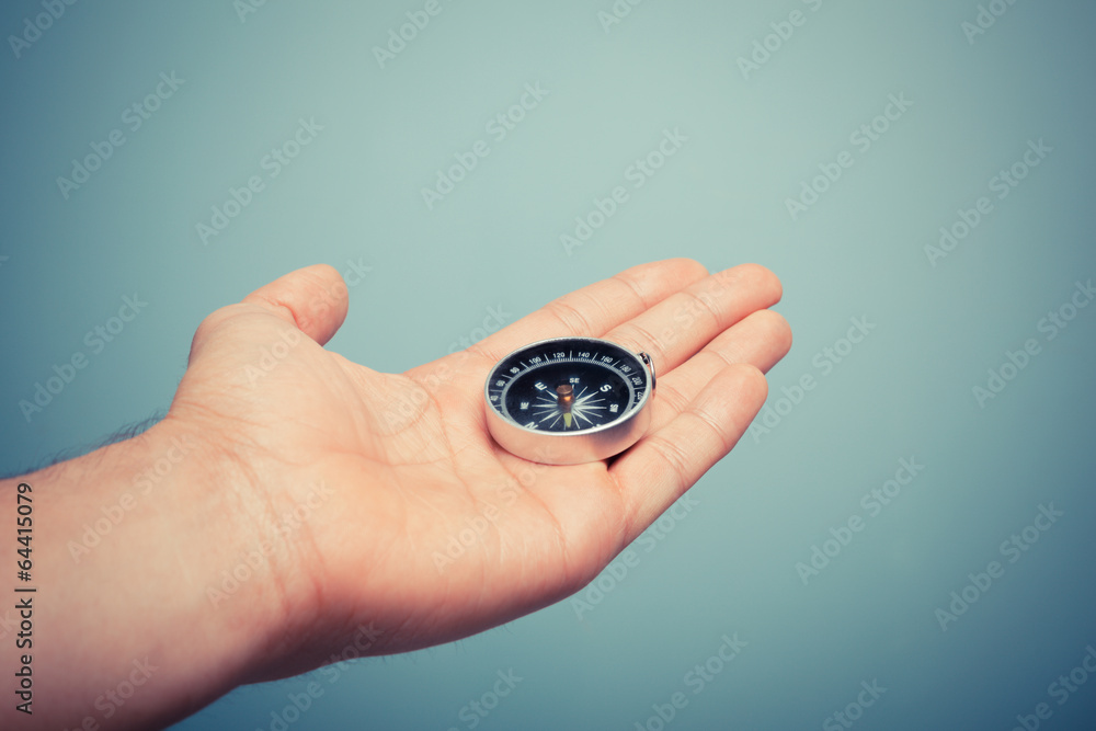 Hand holding compass Stock Photo | Adobe Stock