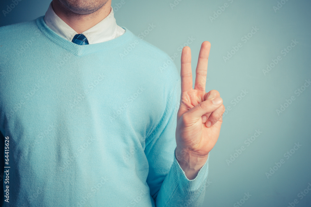 Man giving peace sign Stock Photo | Adobe Stock