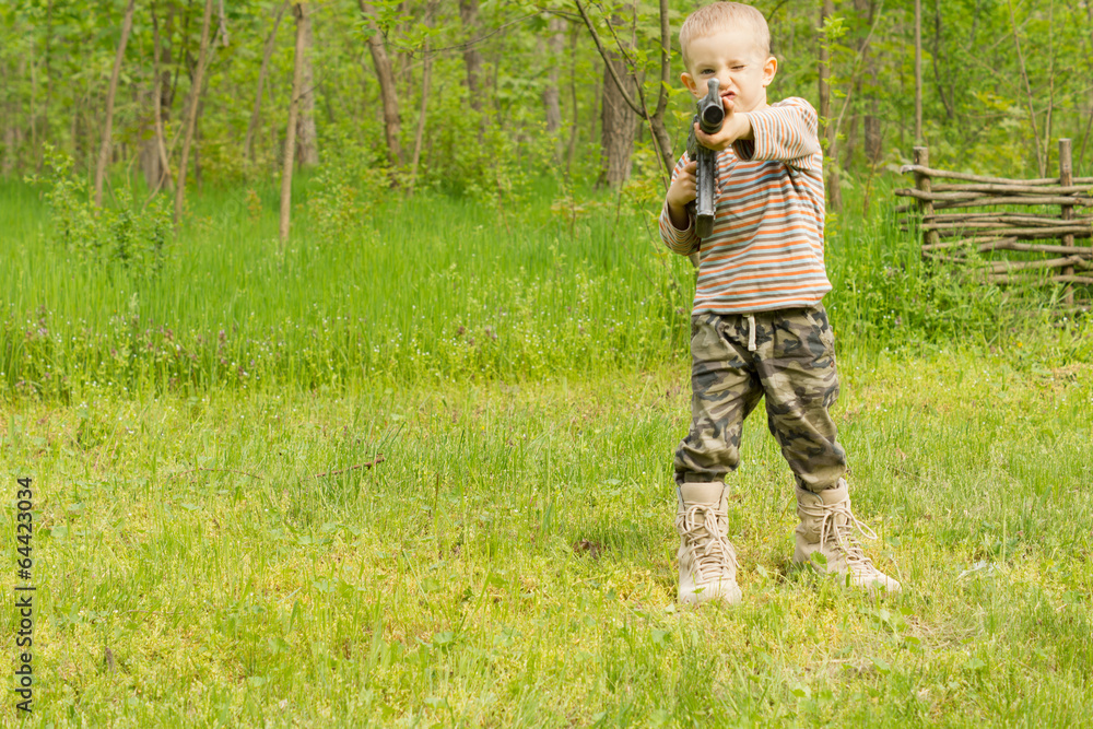 Little boy pointing an automatic weapon Stock Photo | Adobe Stock