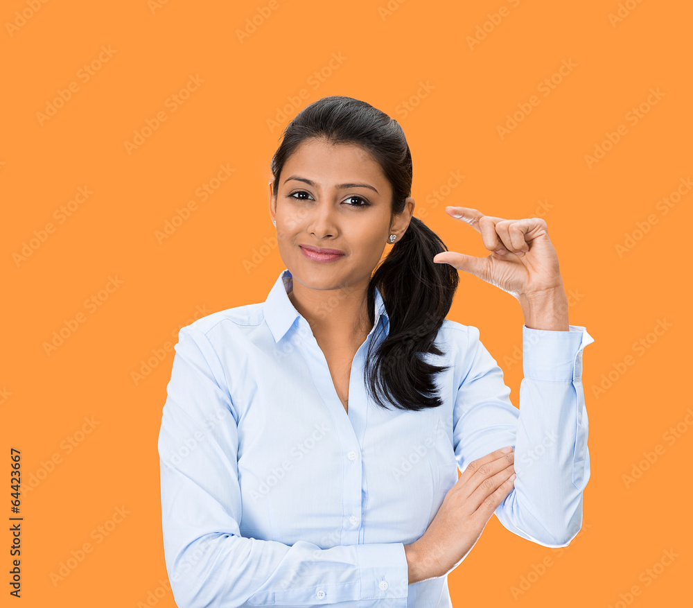 Woman showing small size hand gesture on orange background Stock Photo ...