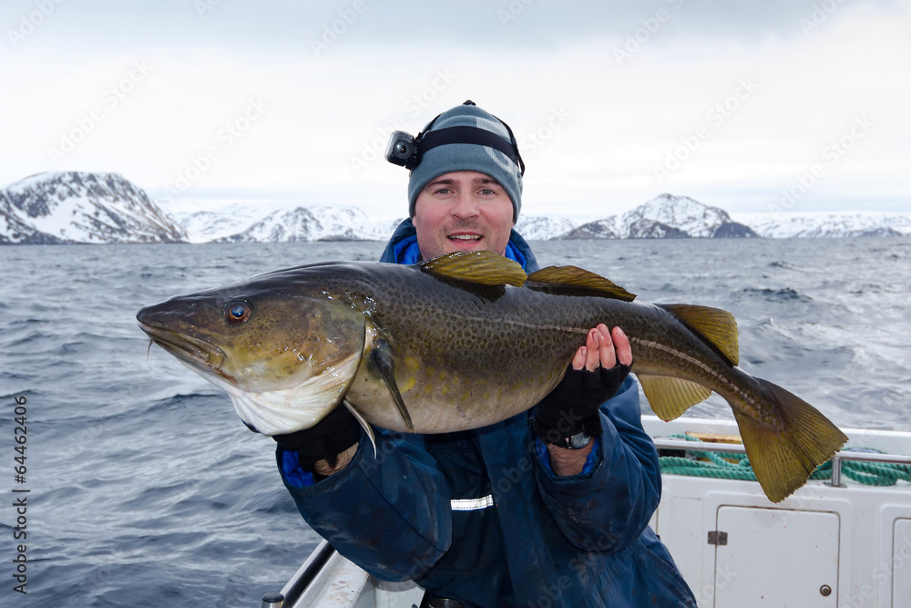 Happy angler with huge cod fish Stock Photo | Adobe Stock
