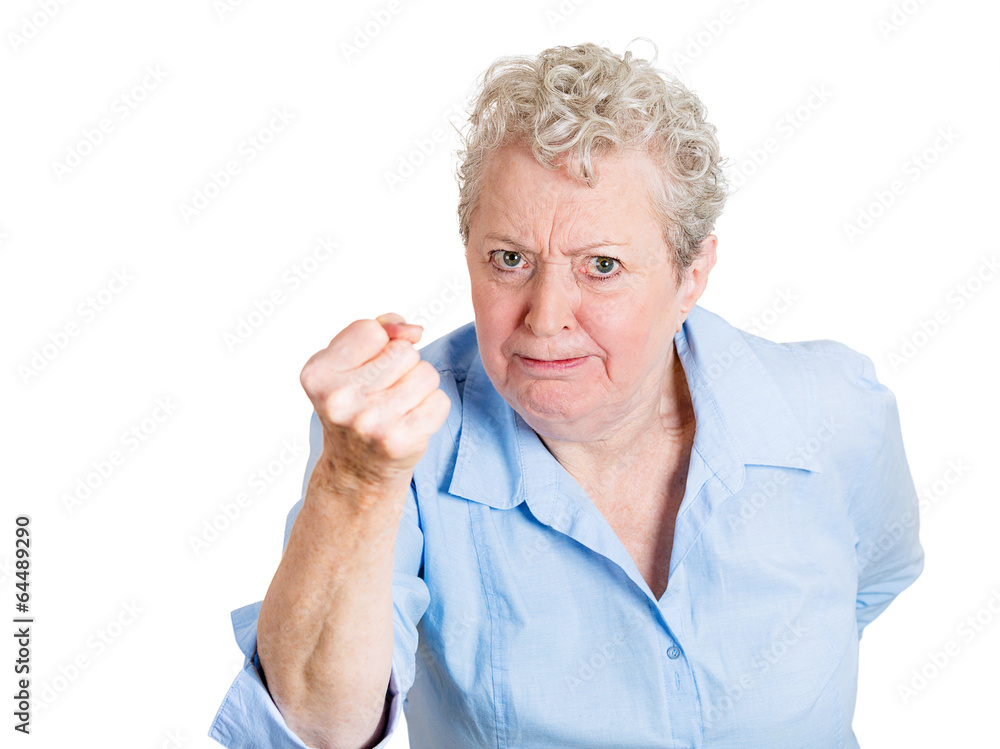 Foto de Angry elderly, senior woman, upset with someone, fist up in air ...