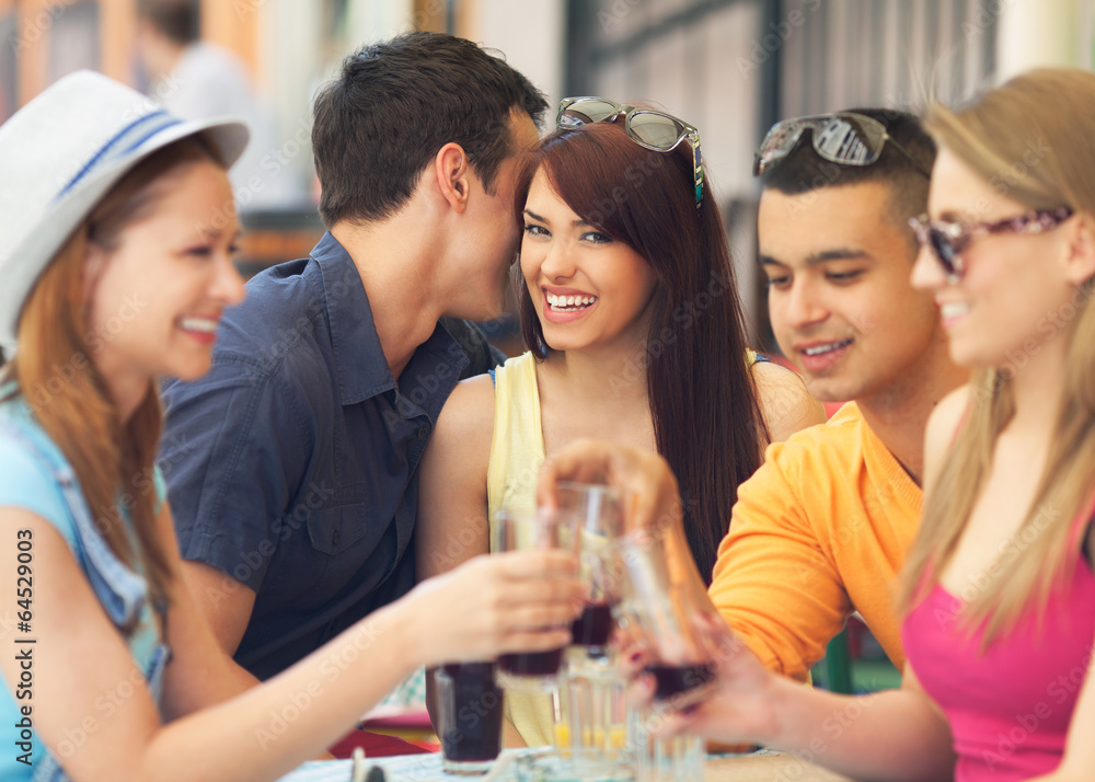 Young friends sitting on table in cafe Stock Photo | Adobe Stock