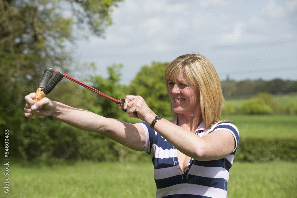 Woman firing a catapult Stock Photo | Adobe Stock