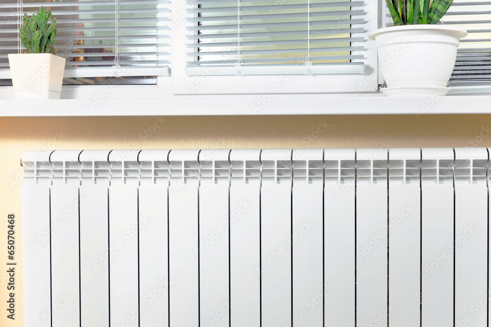 Heating white radiator radiator with flower and window. Stock Photo ...