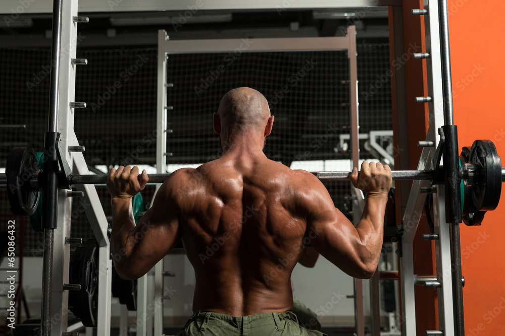Shoulder Exercises On A Smith Machine Stock Photo | Adobe Stock