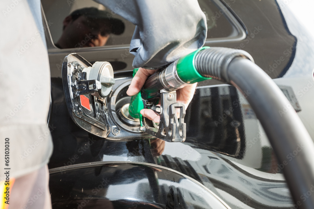 Man fueling up a car фотография Stock | Adobe Stock