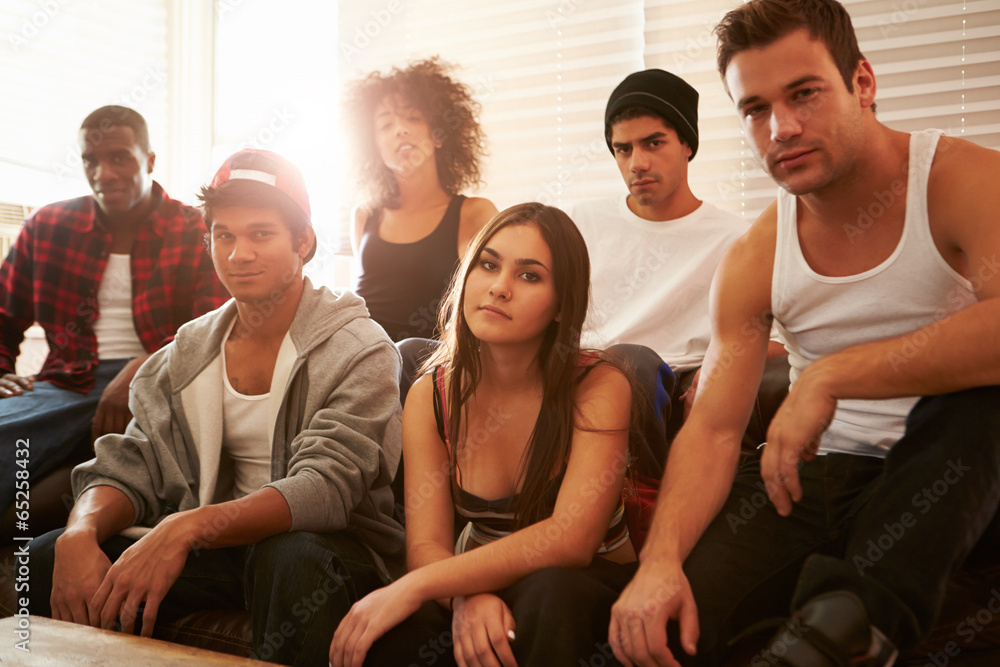 Portrait Of Gang Members Sitting On Sofa In House Stock Photo | Adobe Stock