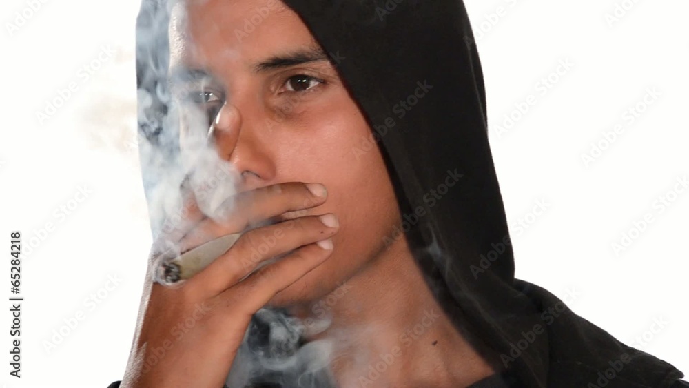 close up of young man smoking hashish joint on white background. Stock ...