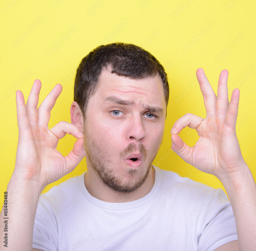 Portrait of funny man showing OK gesture with hands against yell Stock ...