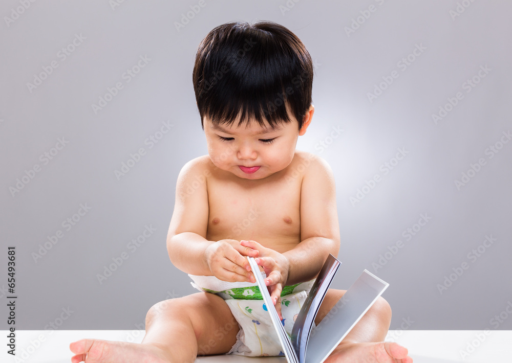 Baby boy reading book Stock Photo | Adobe Stock