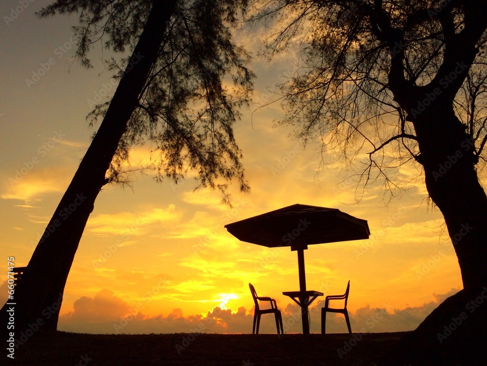 restaurant table on beach at sunrise Stock Photo | Adobe Stock